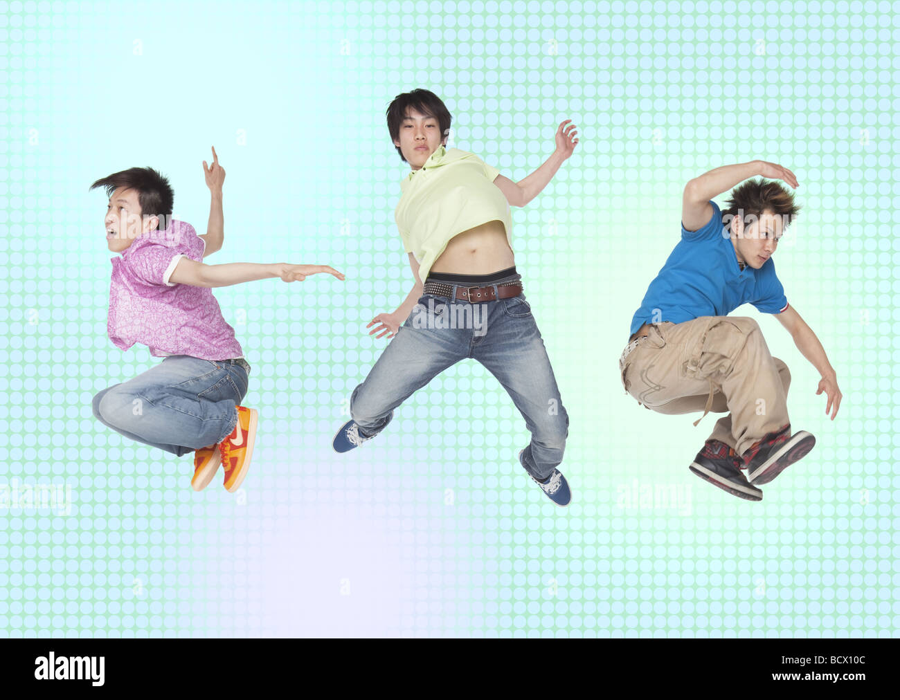 Young men jumping Stock Photo - Alamy