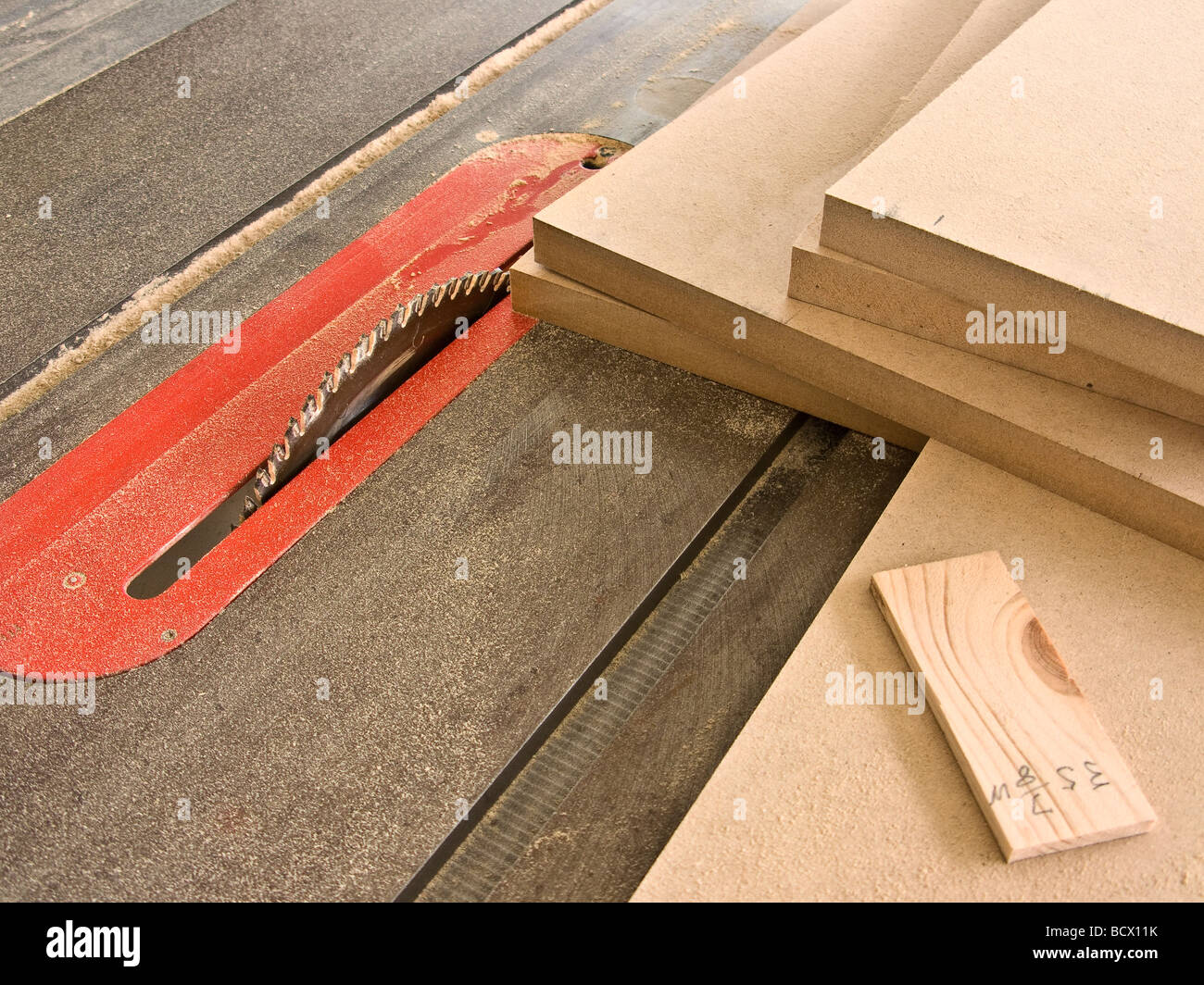 Table saw with stack of MDF wood Stock Photo - Alamy