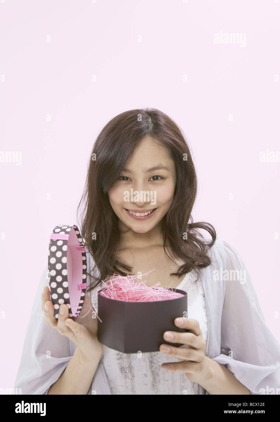 Young woman opening present Stock Photo - Alamy