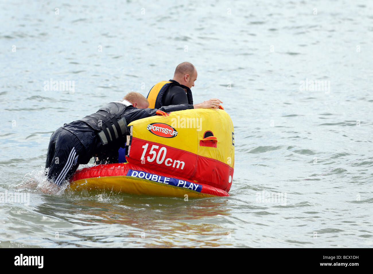 Climmbing into an inflatable chariot on Southampton Water Stock Photo ...