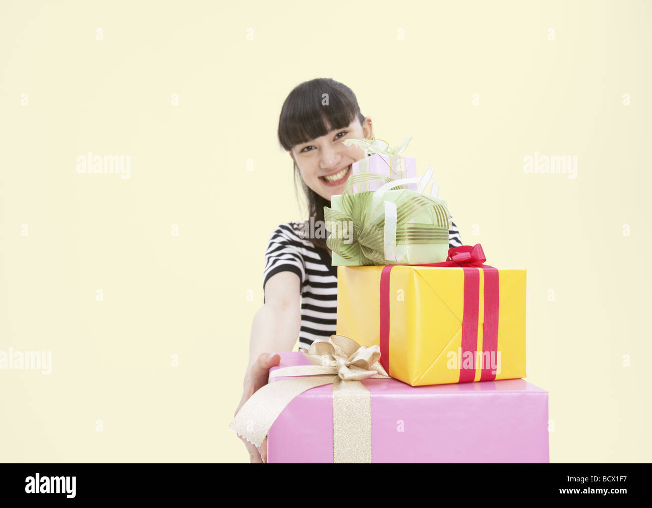 Young woman giving presents Stock Photo - Alamy