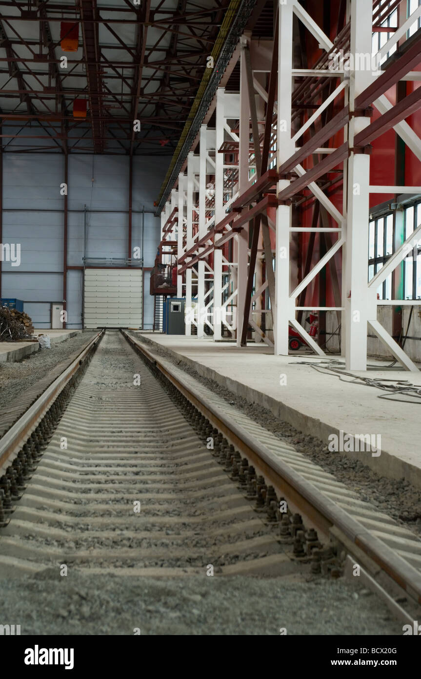 Railroad going into the distance in hangar near from hardware Metal ...