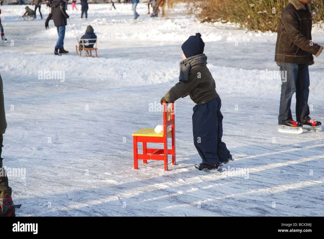 small child practising with chair on natural ice Stock Photo - Alamy