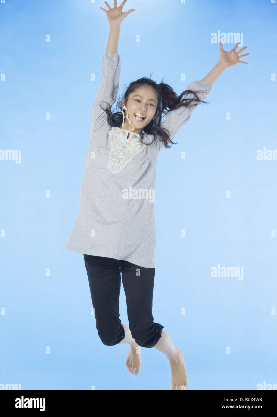 Young woman jumping Stock Photo - Alamy