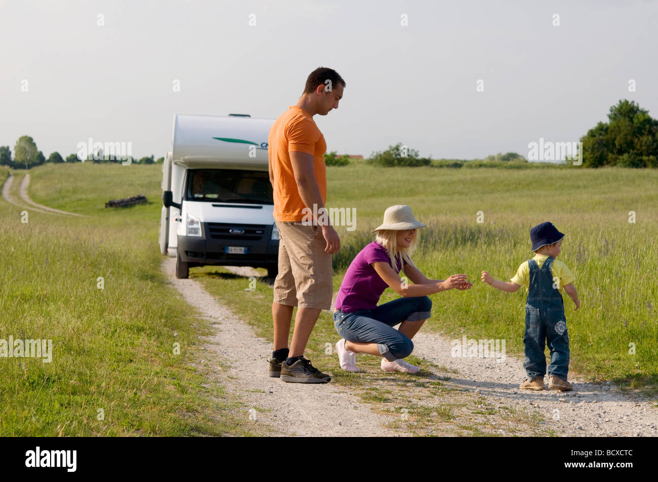 family with camper in countryside Stock Photo - Alamy