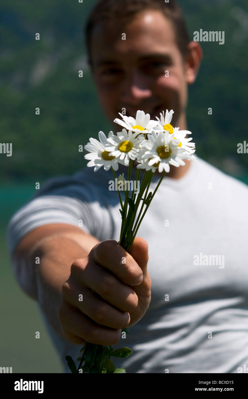 man holding daisy Stock Photo - Alamy