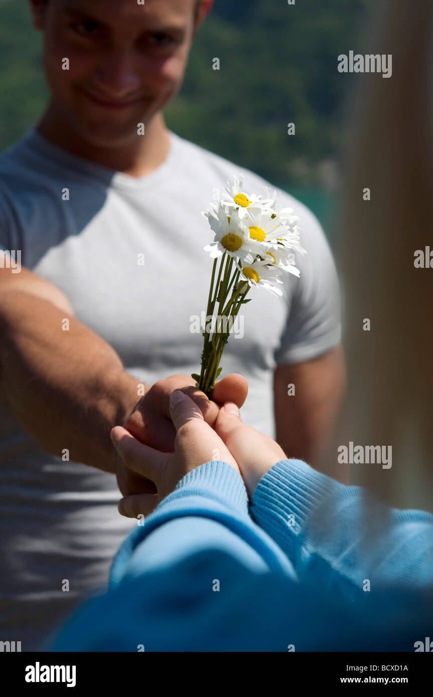man giving flowers to young woman Stock Photo - Alamy