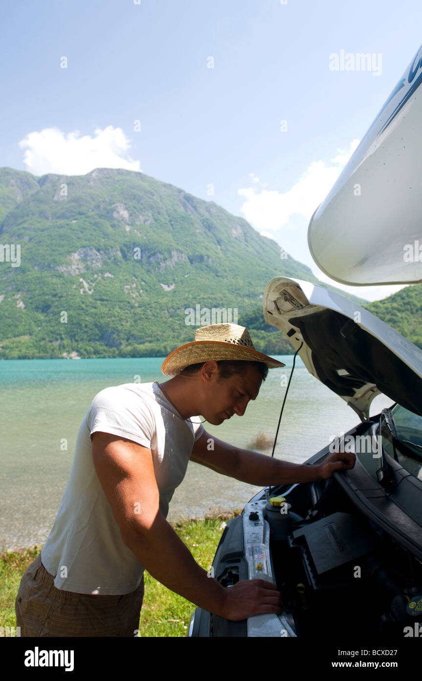 young man looking under camper bonnet Stock Photo - Alamy