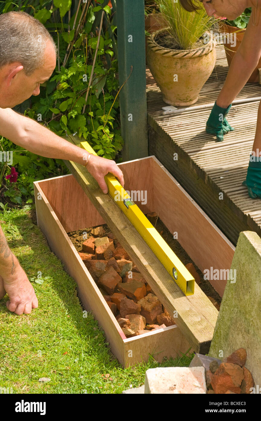 Handyman and Female Helper Using a Spirit Level Stock Photo - Alamy