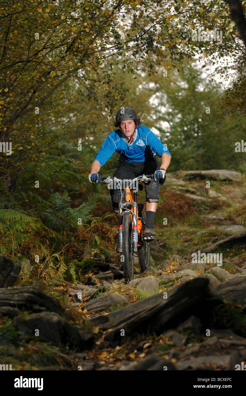 A mountain biker rides over rocks Stock Photo - Alamy
