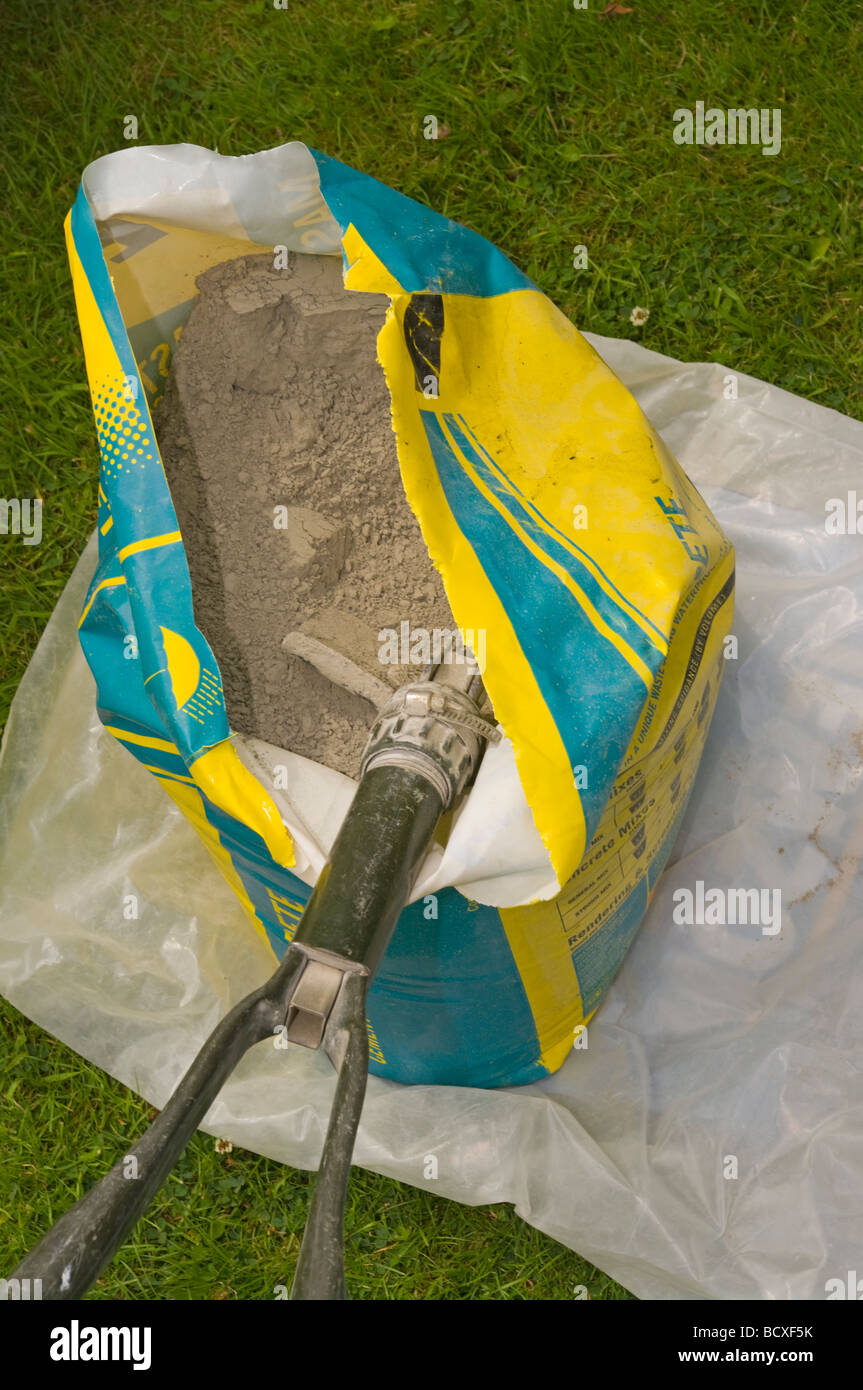 Spade In a Bag Of Cement Stock Photo - Alamy