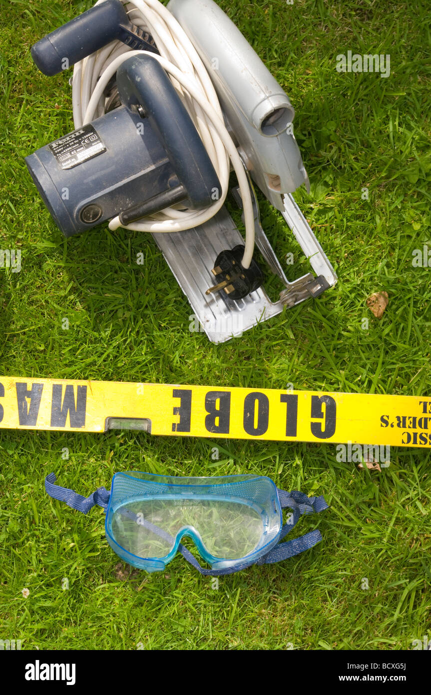 Builders Tools A Spirit Level Safety Goggles and an Electric Circular ...