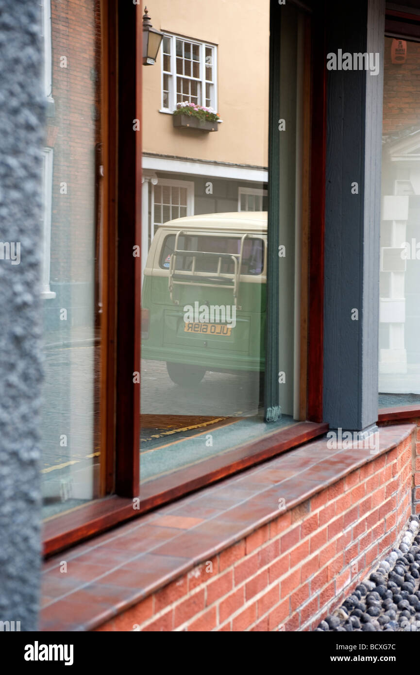 A reflection of a volkswagen camper van in a window Stock Photo - Alamy