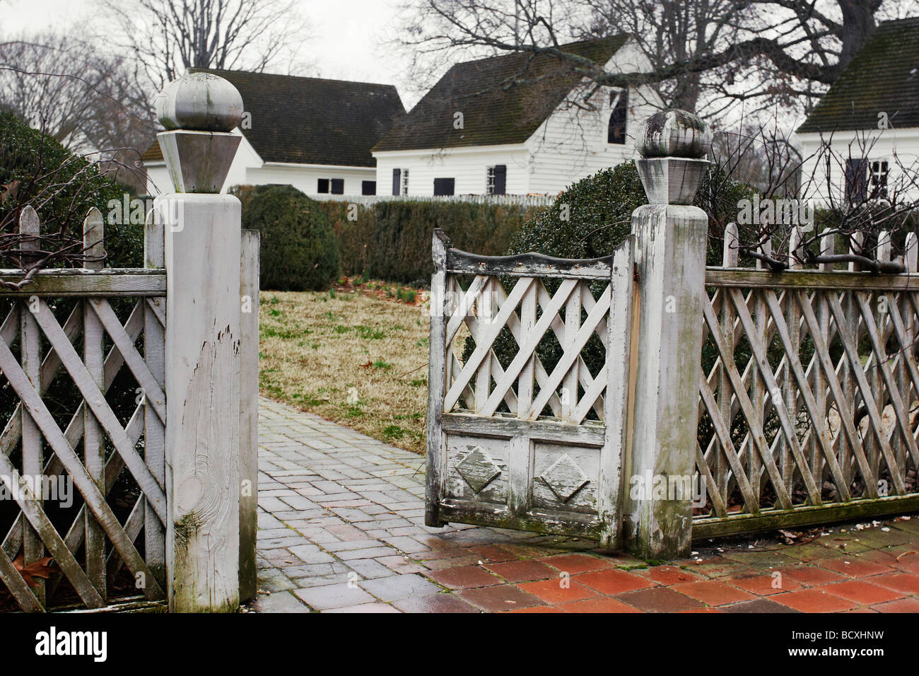 A fence gate and brick path in Colonial Williamsburg Virginia Stock ...