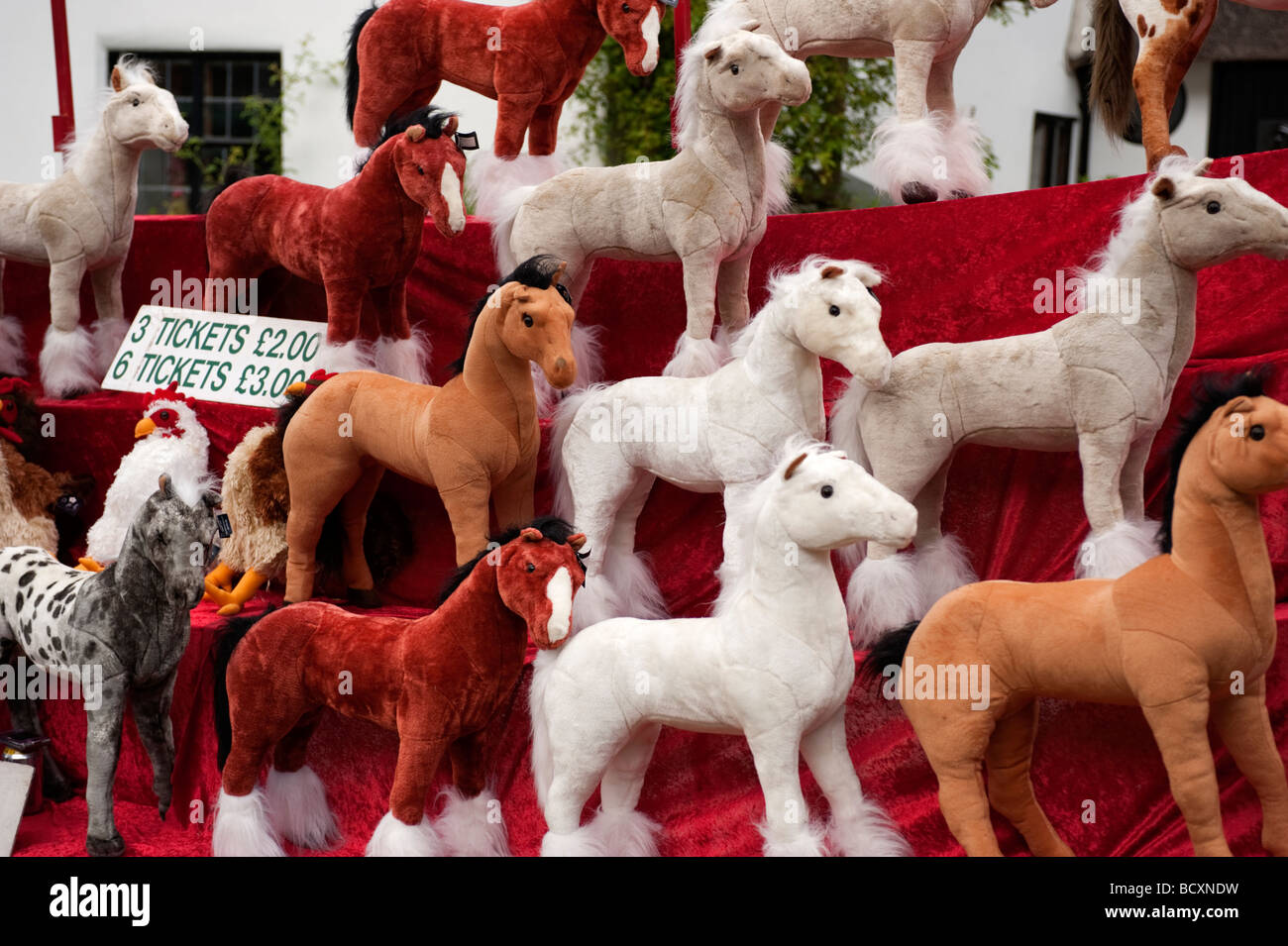 Raffle prizes, soft toys on display on a stall Stock Photo - Alamy