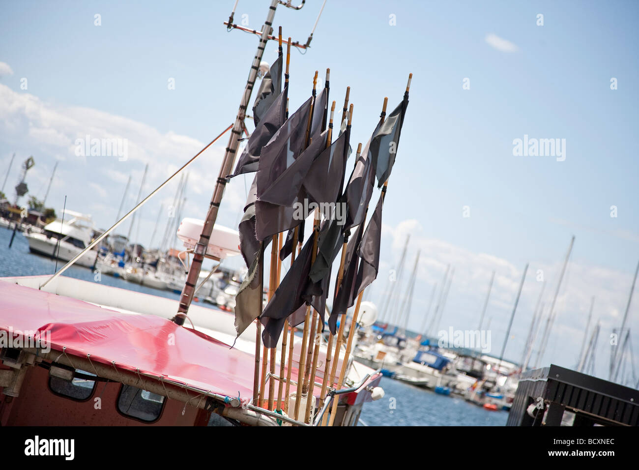 Flags on a small fishingboat Stock Photo - Alamy