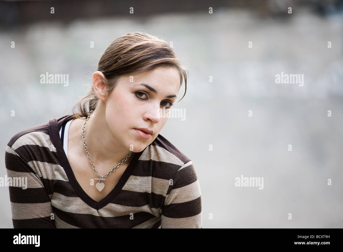 Portrait of a young teenage girl looking serious outdoors Stock Photo ...