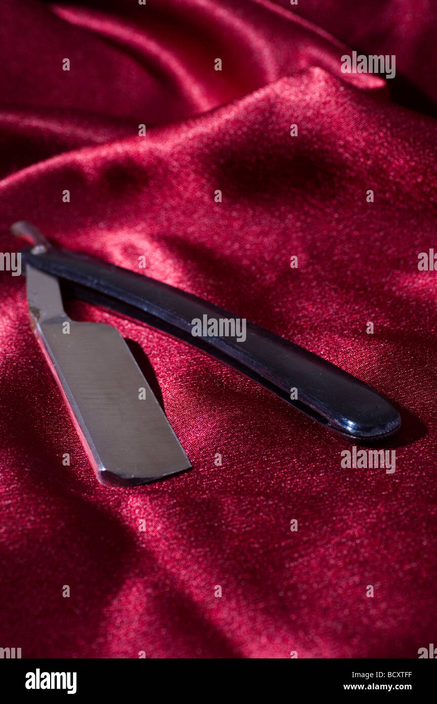 Shaving razor on red satin Stock Photo - Alamy