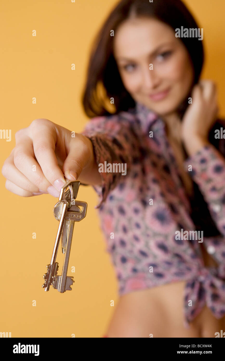 woman holding keys Stock Photo - Alamy