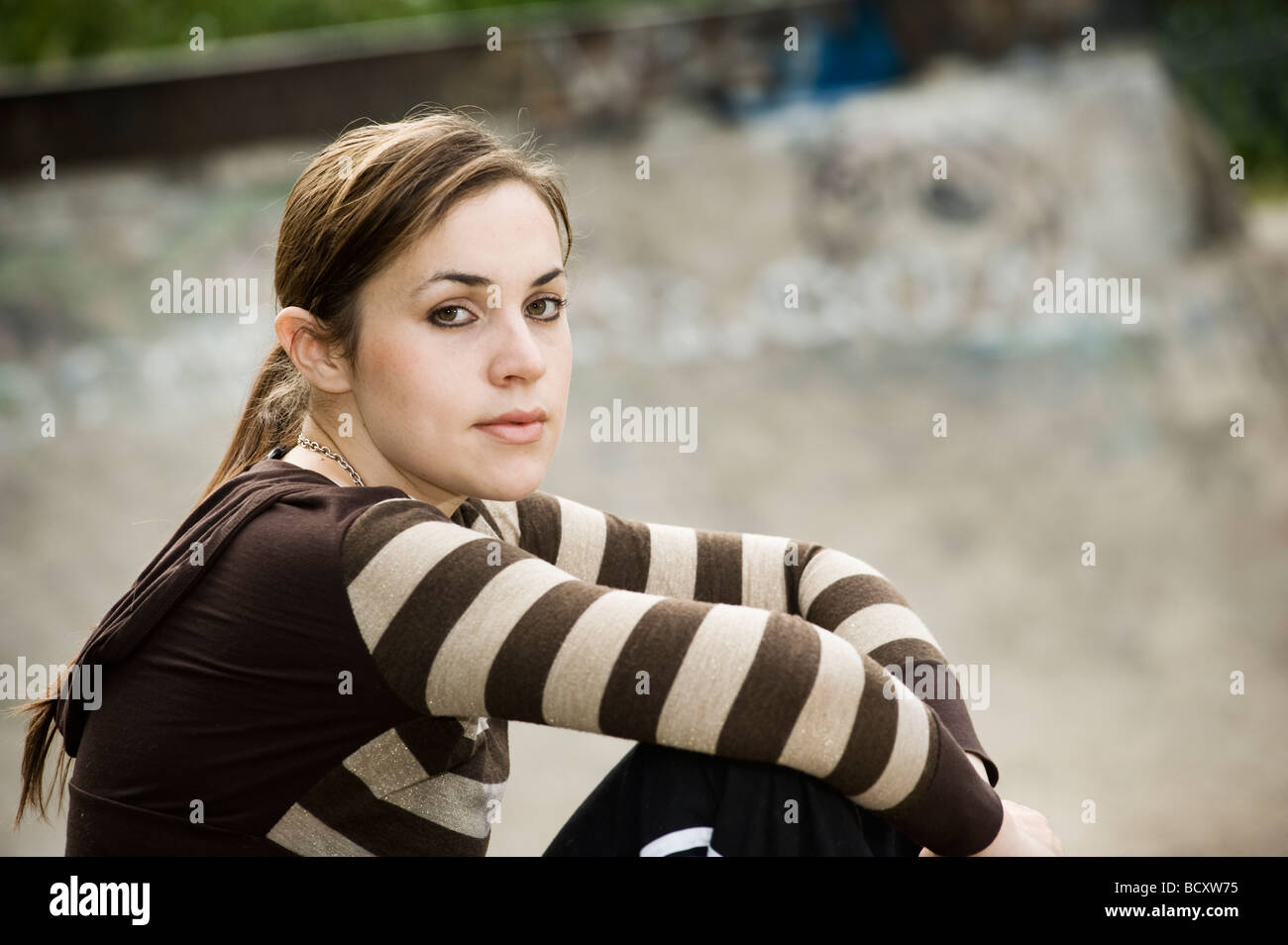Portrait of a young teenage girl looking serious outdoors Stock Photo ...