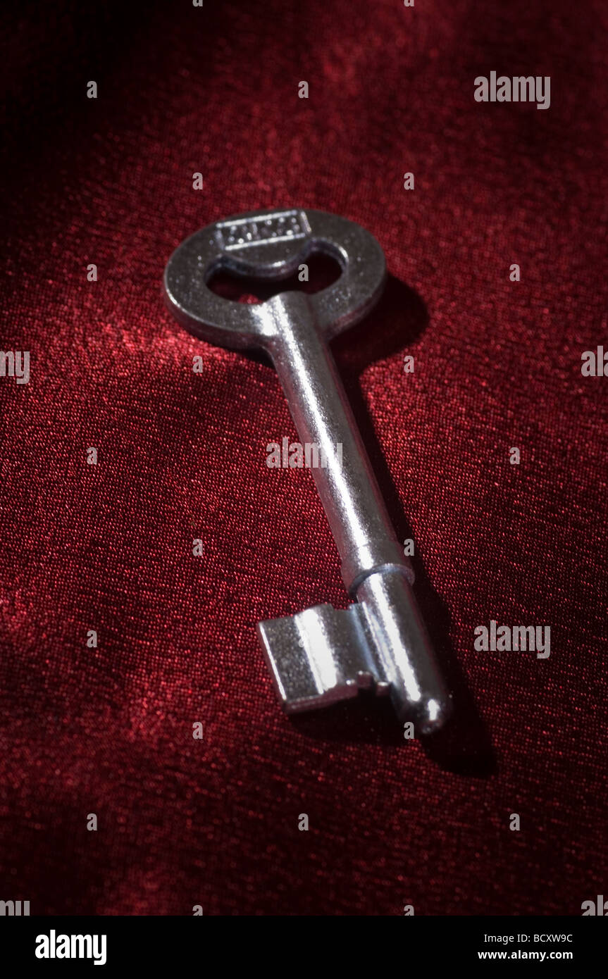 Key on red satin Stock Photo - Alamy