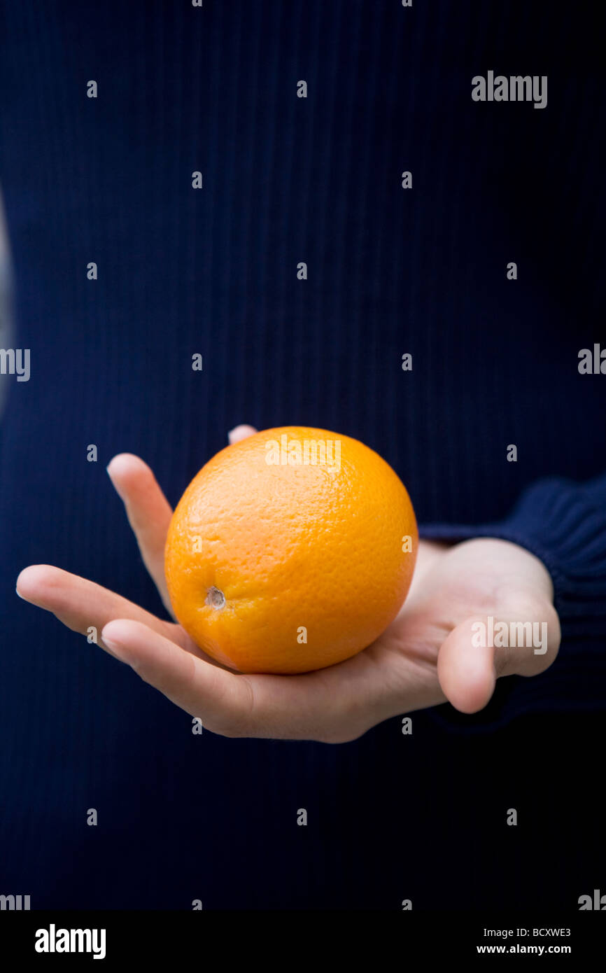 man holding orange Stock Photo - Alamy