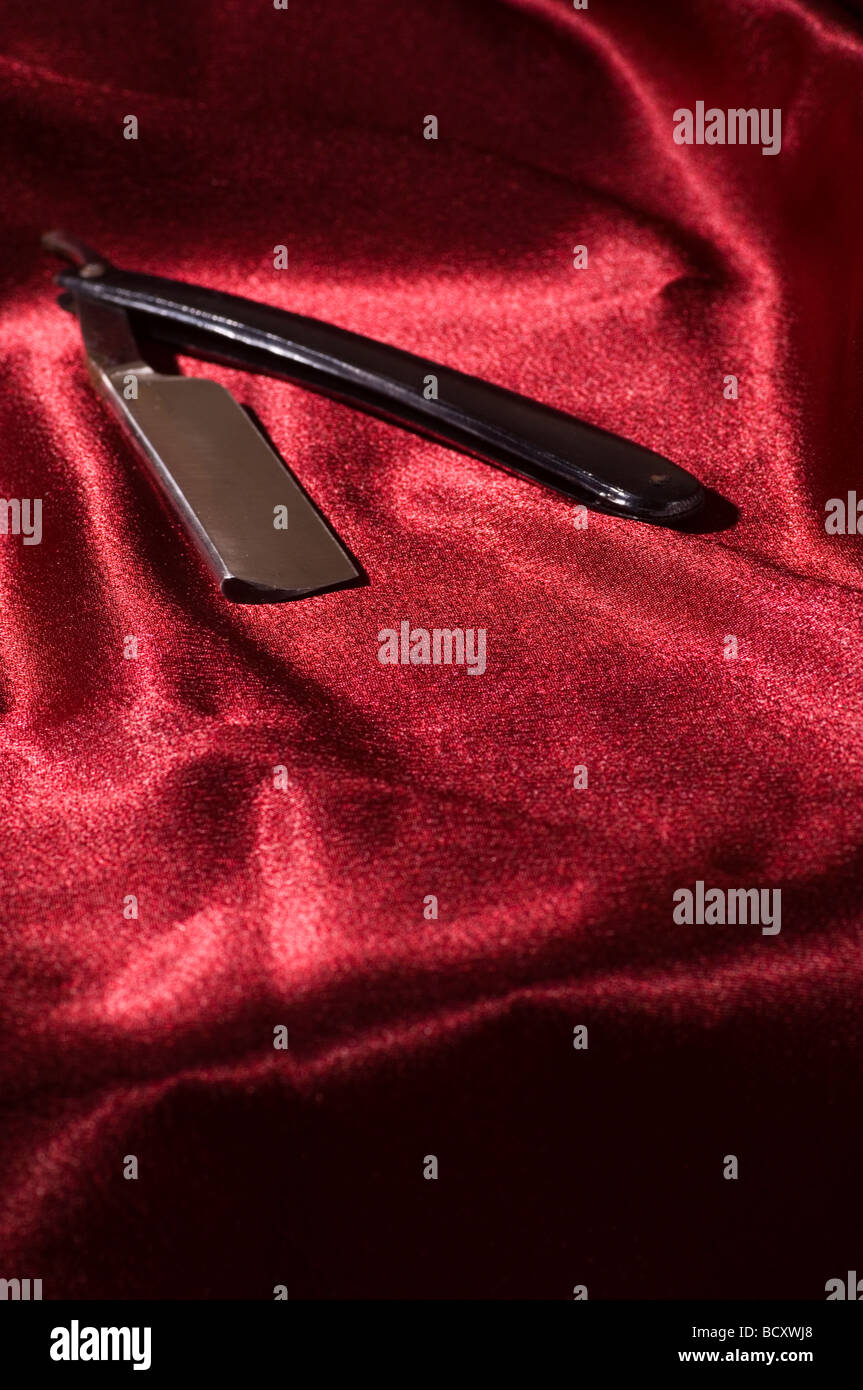 Barber's cutthroat blade on red silk Stock Photo - Alamy
