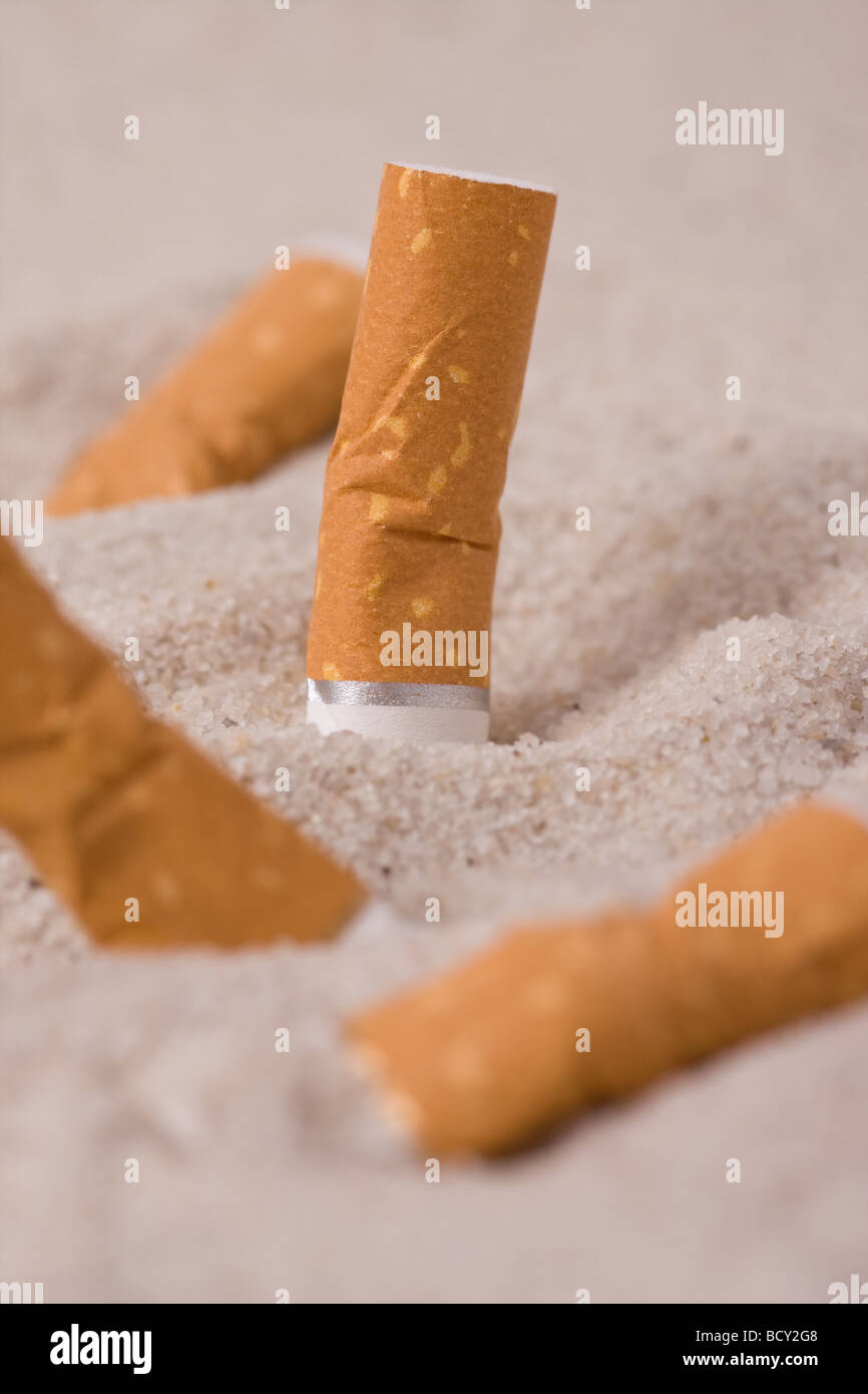 the cigarettes in a sand Stock Photo - Alamy