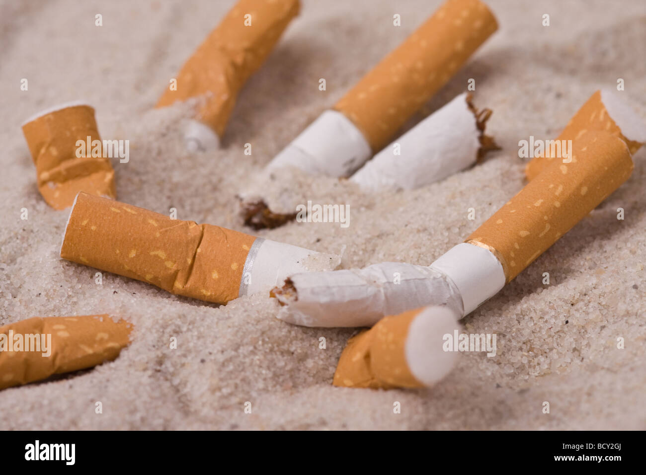 the cigarettes in a sand Stock Photo - Alamy