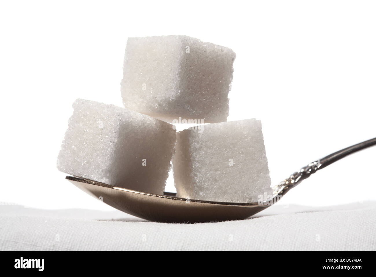 Three cubes of white sugar on spoon Stock Photo - Alamy