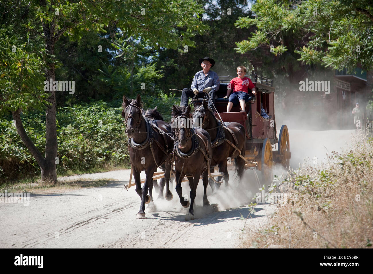 Tourists get aboard a horse-drawn stagecoach for a ride around the ...