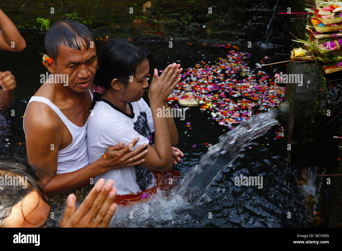 Man and woman at a ceremony at a sacred spring, Tirta Empul at Tampak ...
