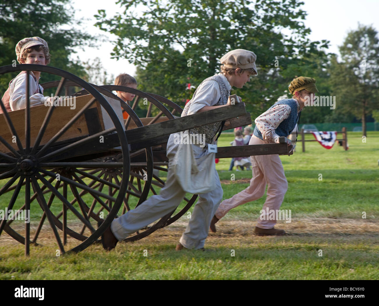 Boys pull hand carts at restored Mormon village of Nauvoo, Illinois ...