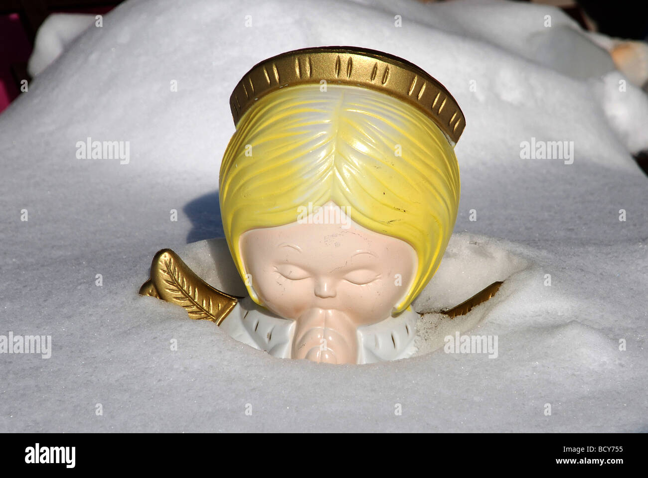 Little praying angle, burried in snow Stock Photo - Alamy