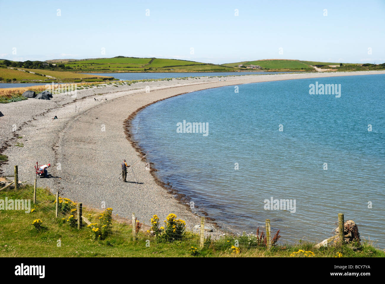 Shingle beach and brackish lagoon at Cemlyn Bay Anglesey North Wales ...