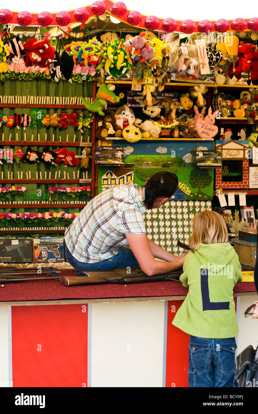 boy at shooting gallery on fairground Stock Photo - Alamy