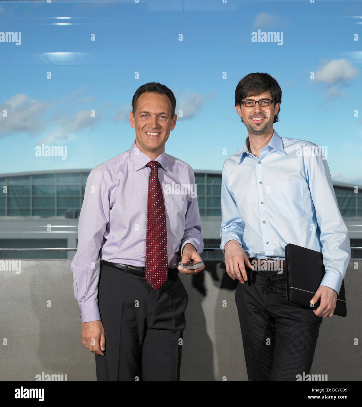 Two Businessmen smiling Stock Photo - Alamy