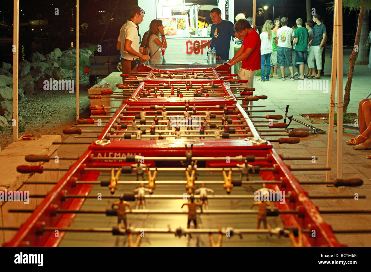Young people playing table football at night Stock Photo - Alamy