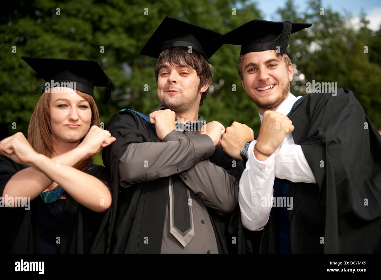 Three Ex students wearing gown and mortar board on Graduation day ...
