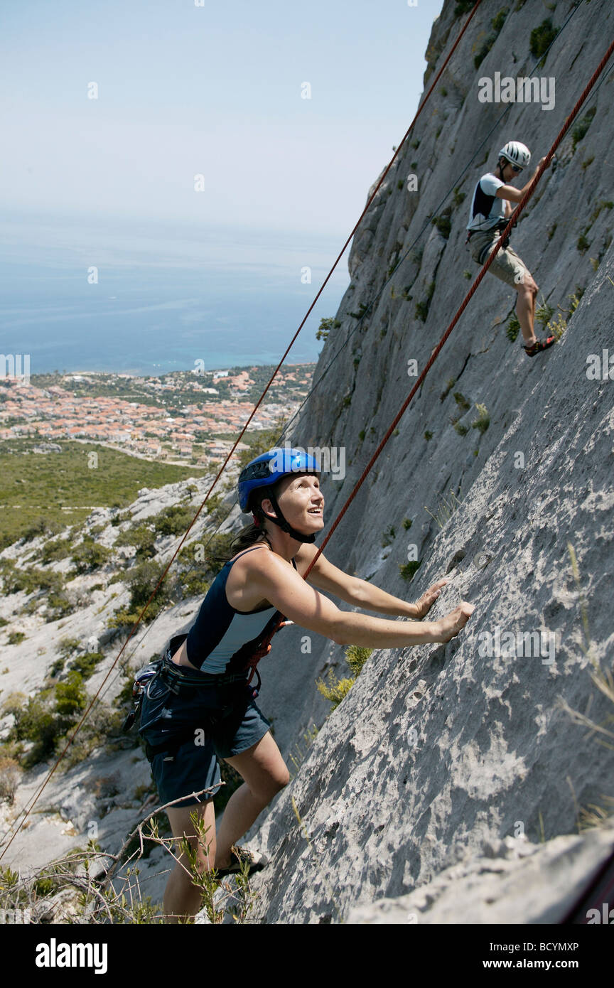 Woman rock climbing Stock Photo - Alamy