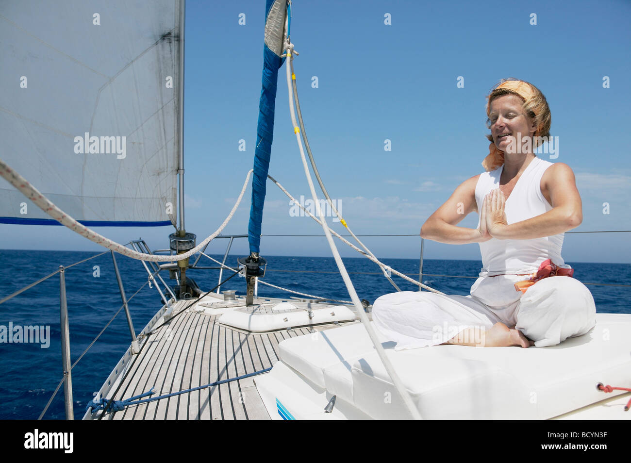 Woman doing yoga on Sailing Boat Stock Photo - Alamy