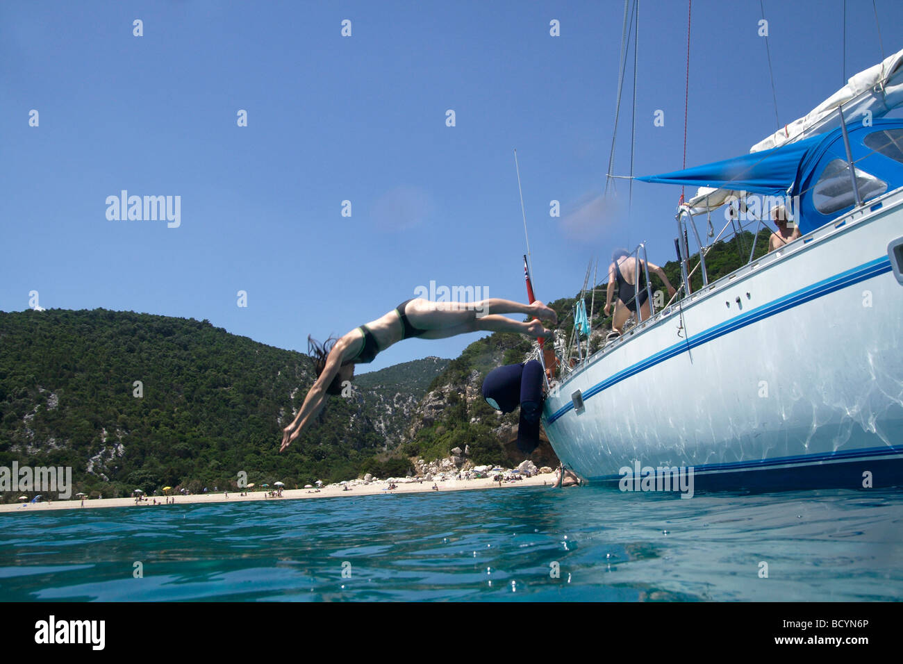 Woman diving into water from boat Stock Photo - Alamy