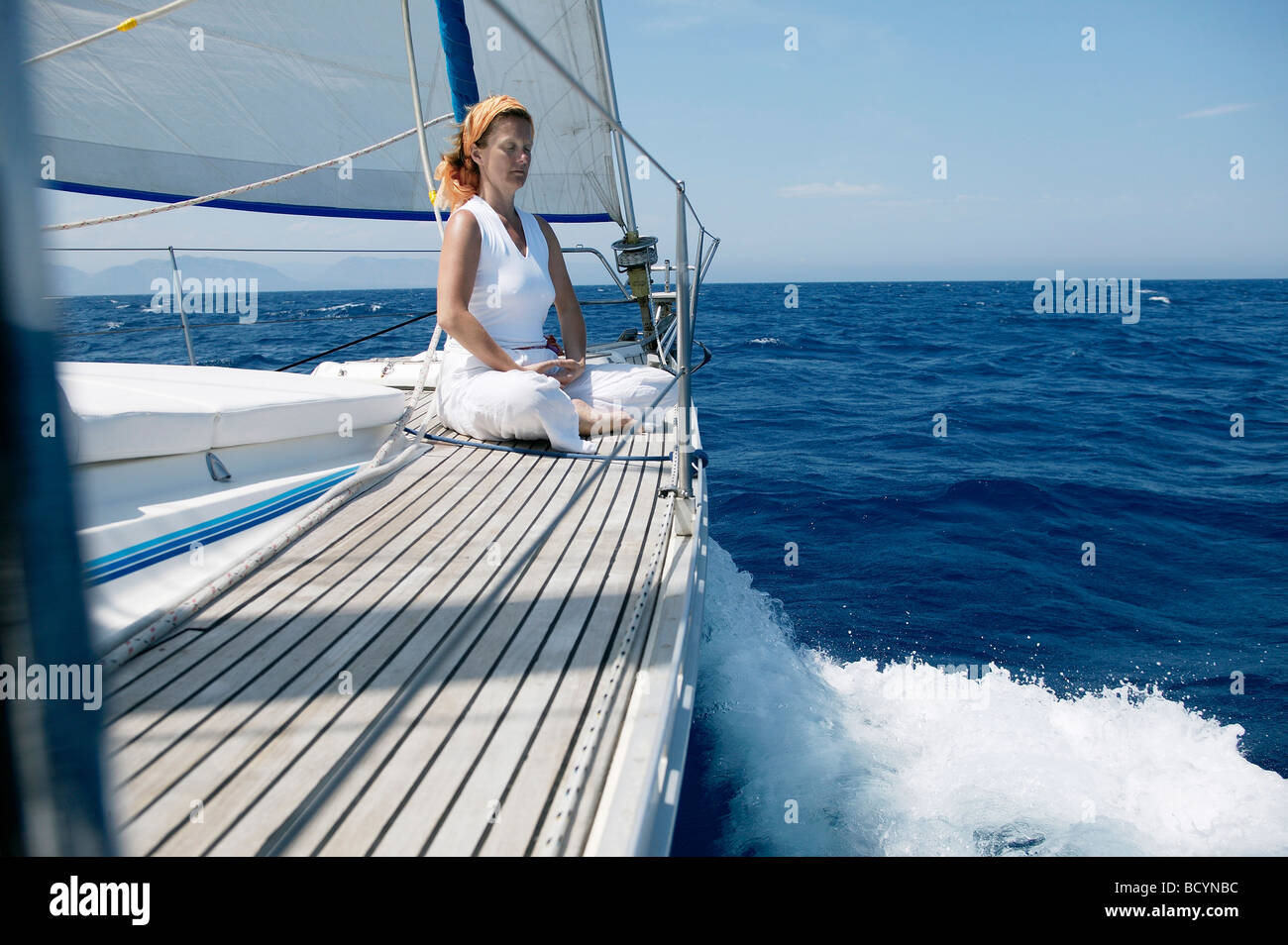 Woman doing yoga on Sailing Boat Stock Photo - Alamy