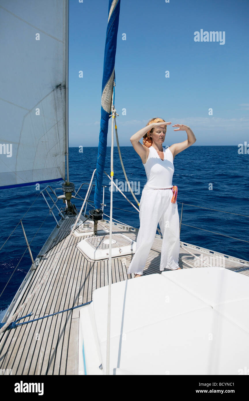 Woman doing yoga on Sailing Boat Stock Photo - Alamy