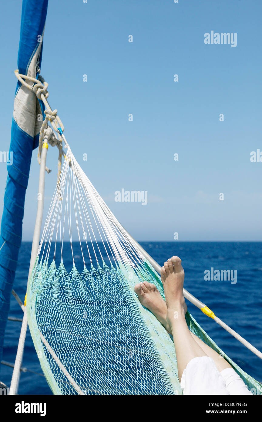 Woman's feet in hammock on sailing boat Stock Photo - Alamy
