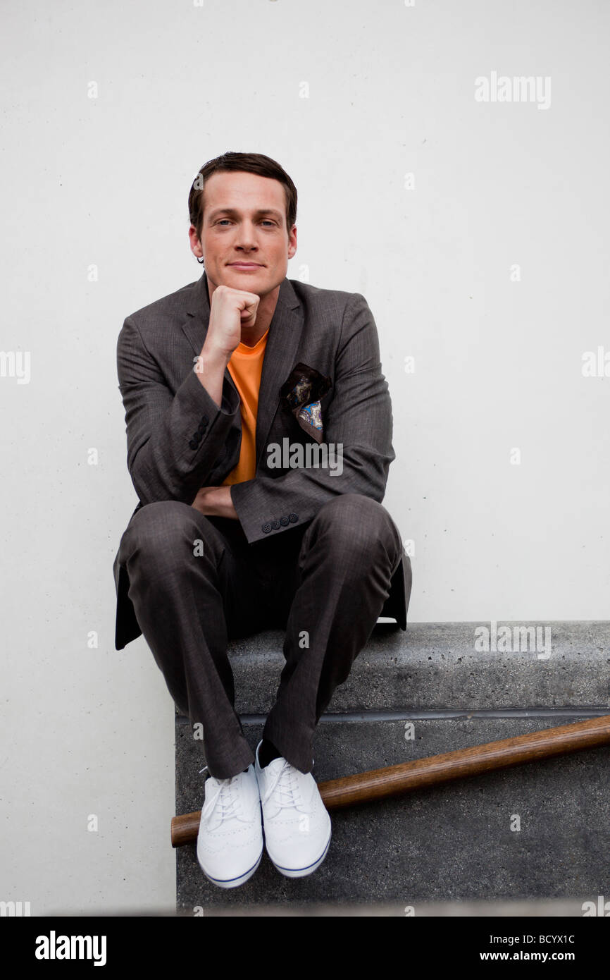 man sitting on railing Stock Photo - Alamy
