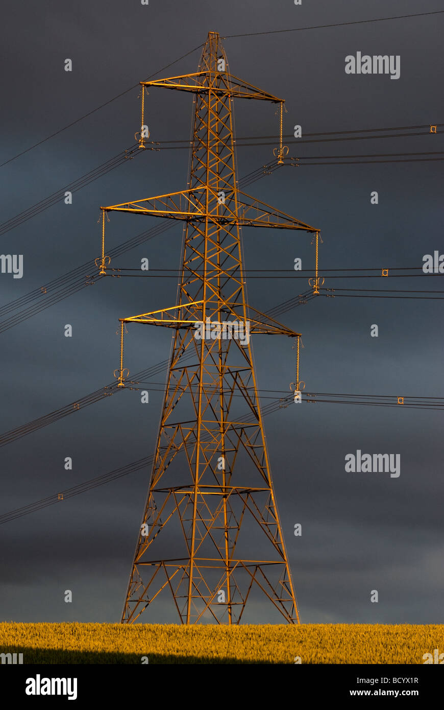 Electricity pylon against a dark sky Stock Photo - Alamy