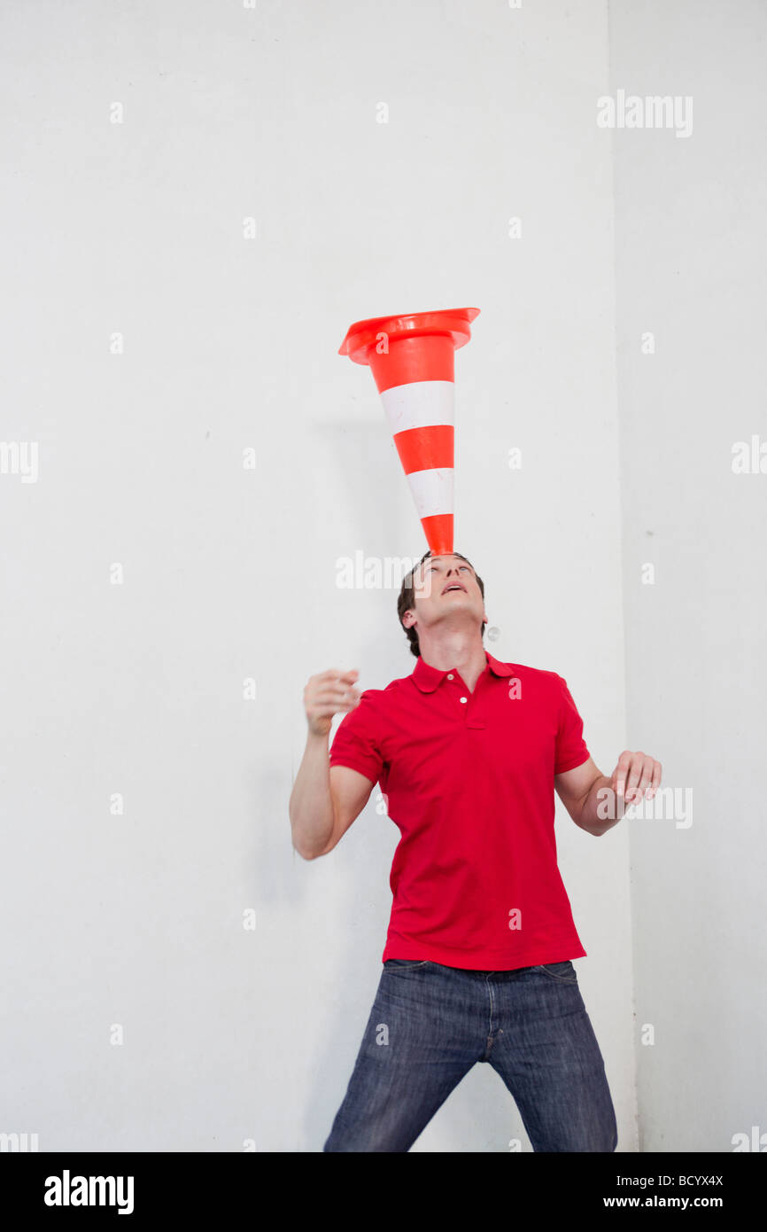 man balancing a pylon on his head Stock Photo - Alamy