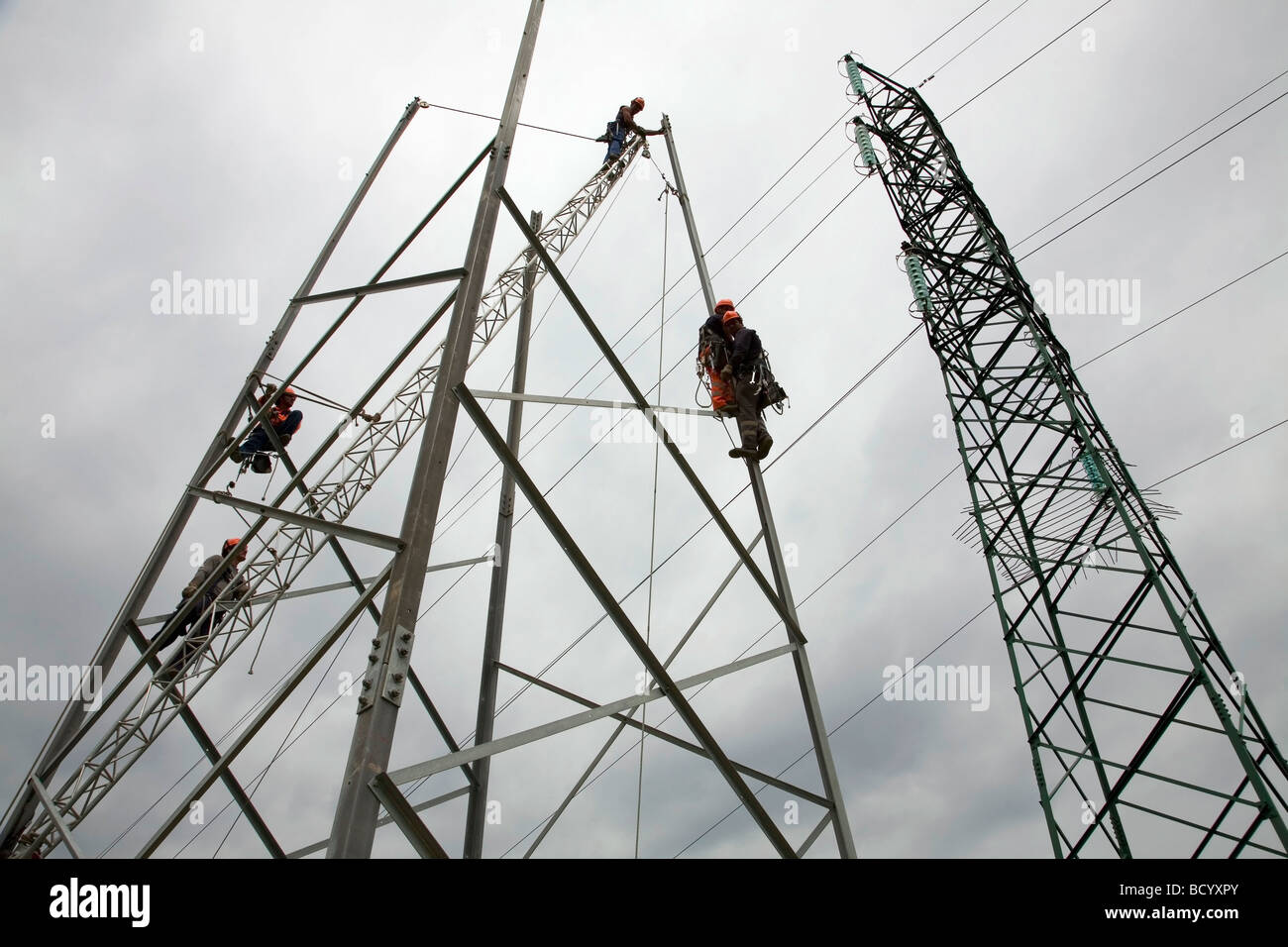 Putting a high voltage pylon together hi-res stock photography and ...