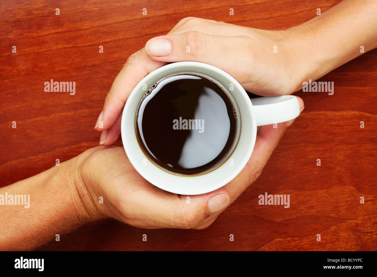 Coffee Cup betwen two hands in a yin and yang manner Stock Photo - Alamy